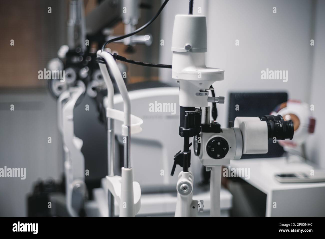A doctor's ophthalmology office, with a white photo-coagulation laser ...