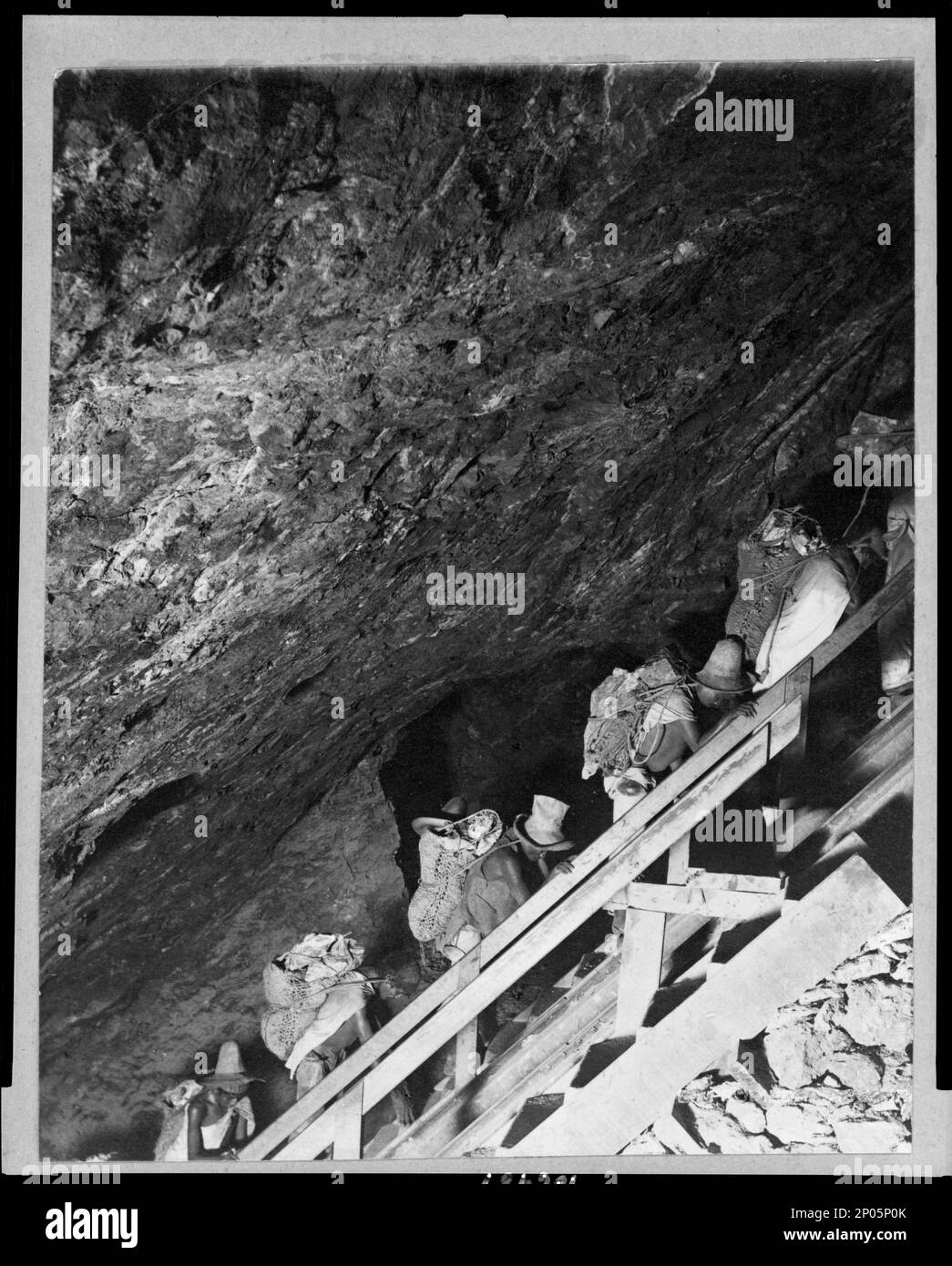 Peasants carrying two-hundred pound bags of silver ore from mines ...
