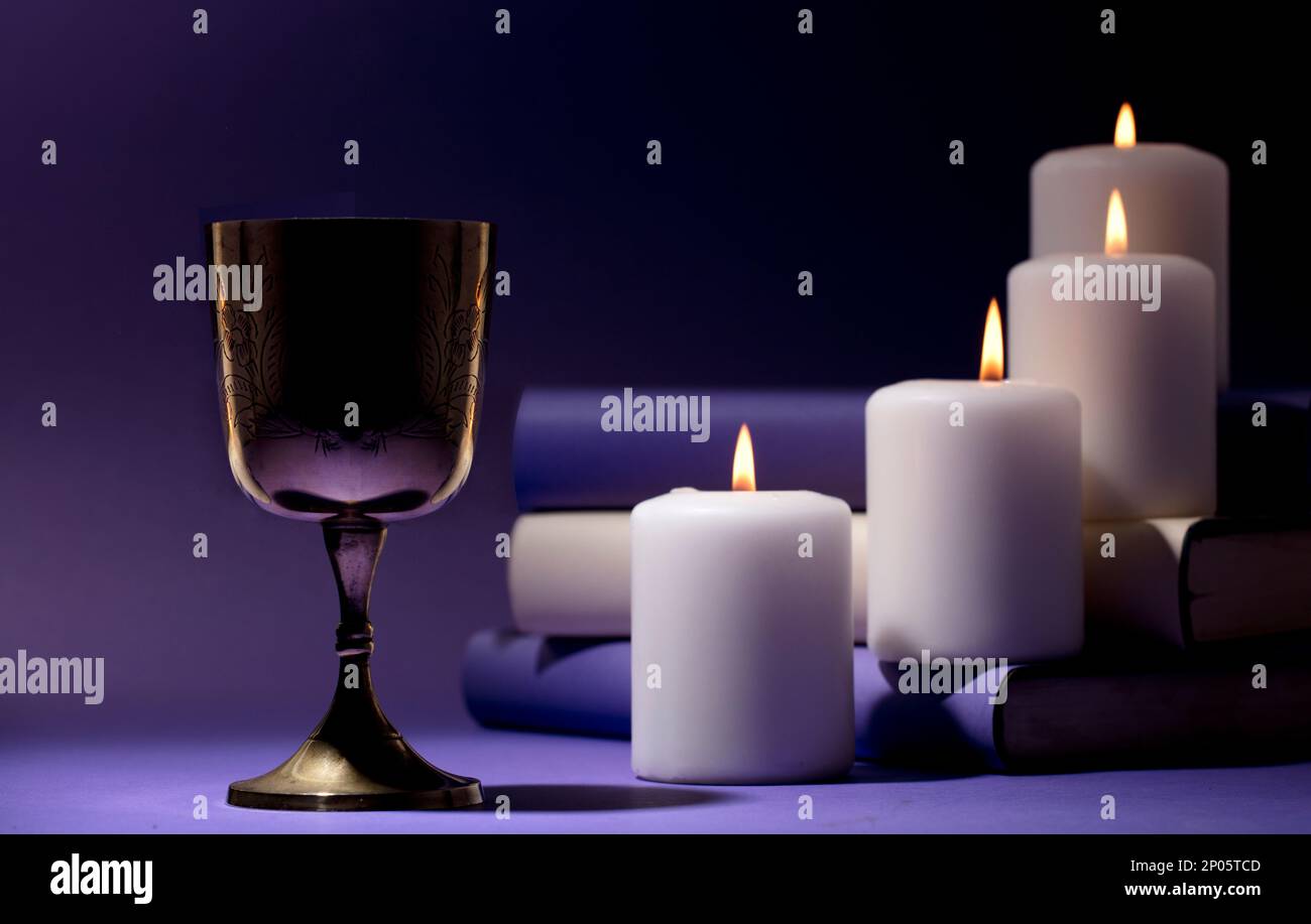 golden christian chalice with candles and purple background Stock Photo ...