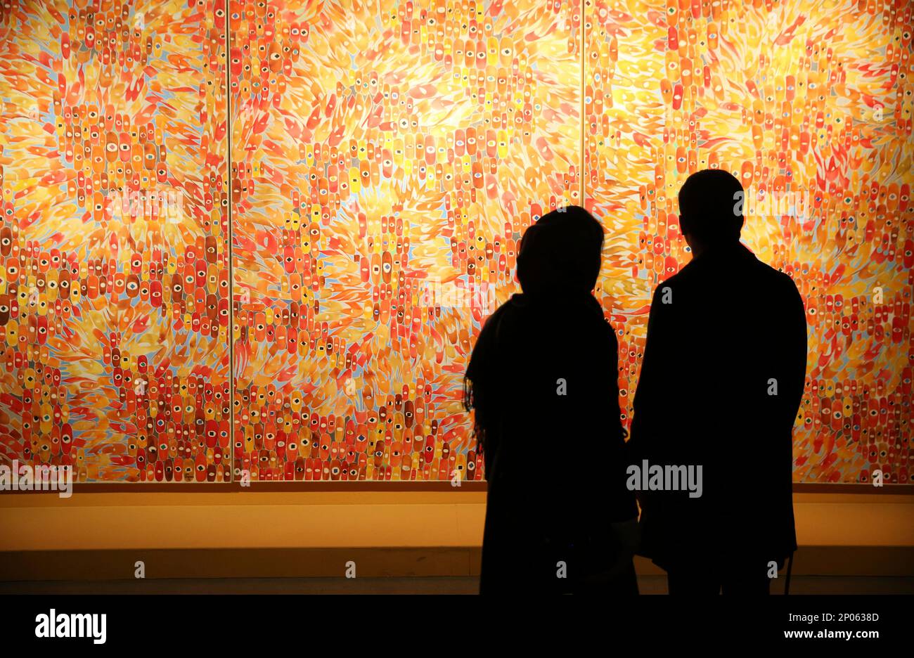 Visitors look at a painting of Hossein Zenderoudi, a prominent Iranian ...