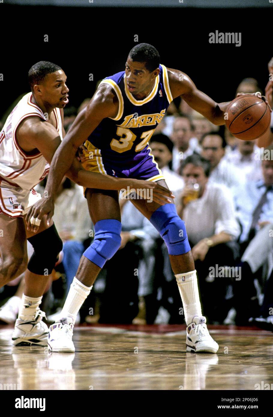 Los Angeles Lakers guard Earvin "Magic" Johnson (32) looks to pass ...