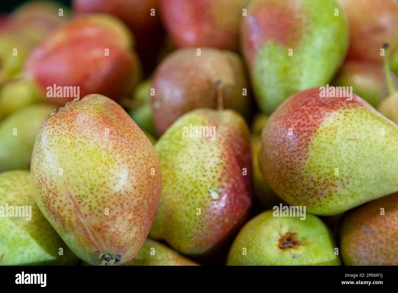 Full frame close-up on a stack of pears for sale on a market stall ...