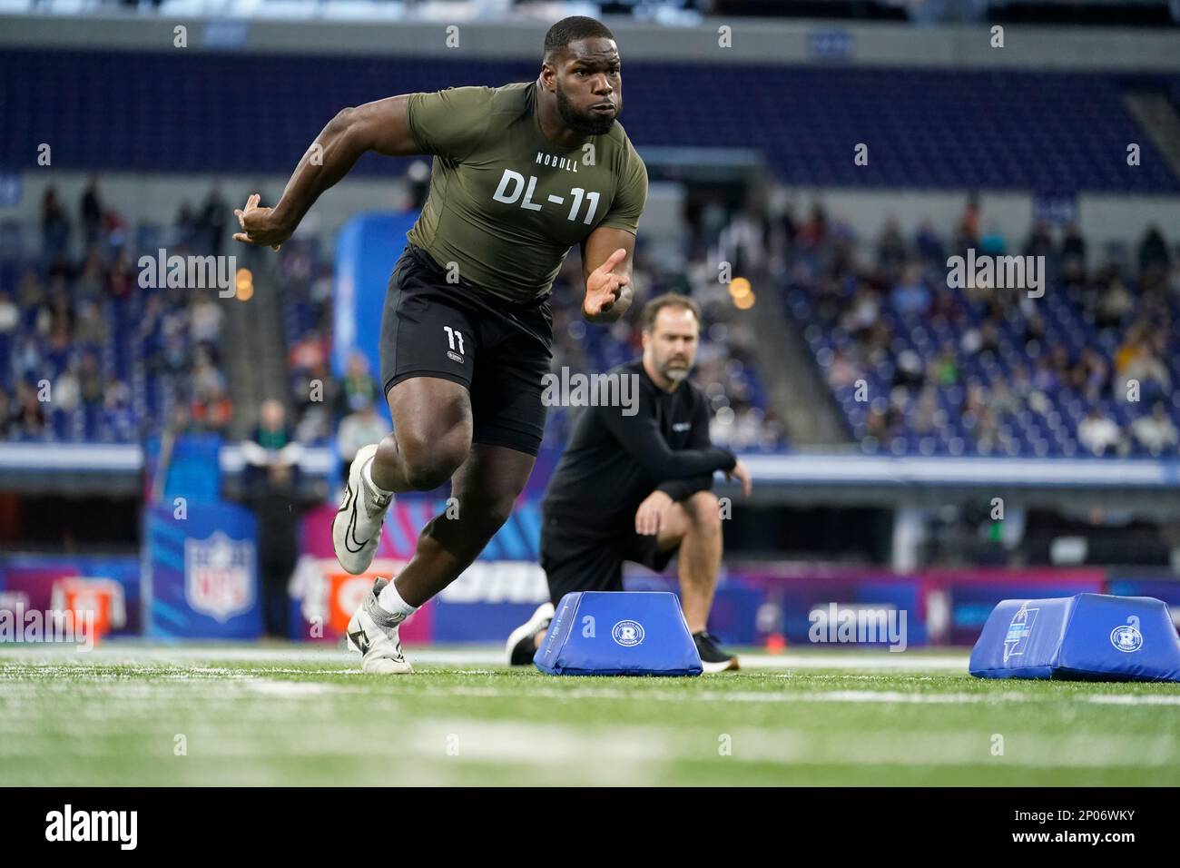 Texas defensive lineman Moro Ojomo runs a drill at the NFL football ...