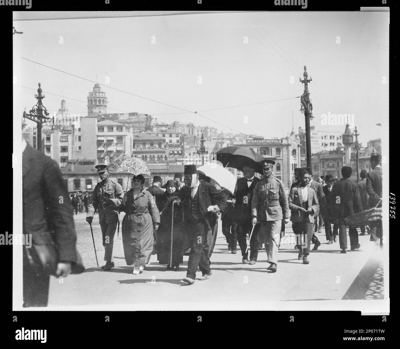 People walking on a street in Istanbul, Turkey, with watch tower in the ...