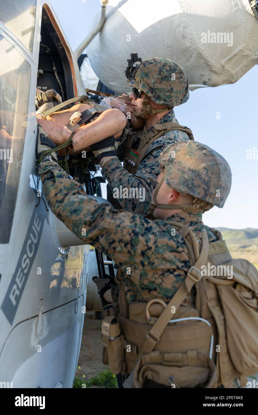 U.S. Marine Corps Lance Cpl. Rickie Hill, top, a crew chief, and Lance ...