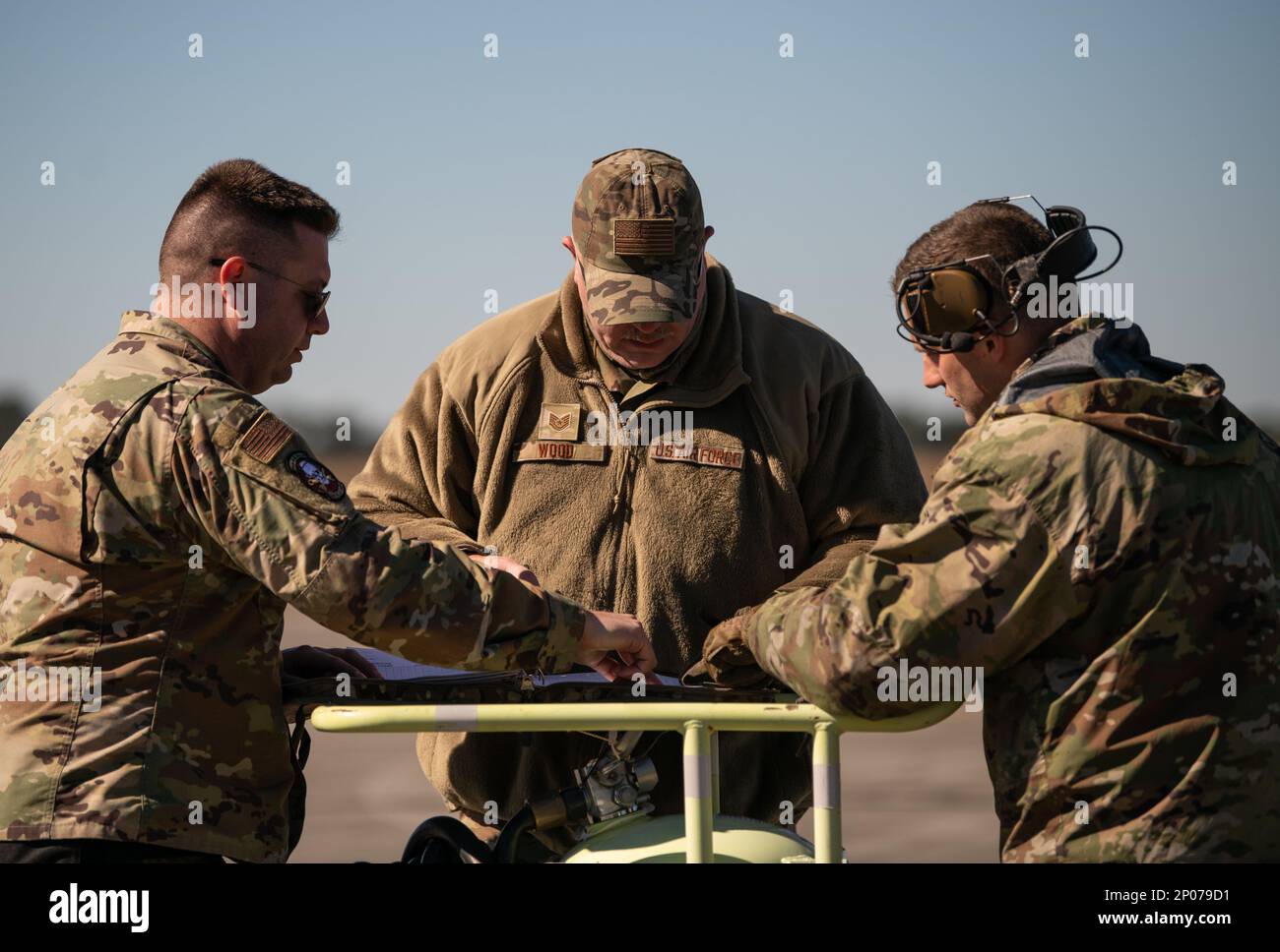 From left, Tech. Sgt. Bret Yerks, an aircraft maintenance crew chief ...