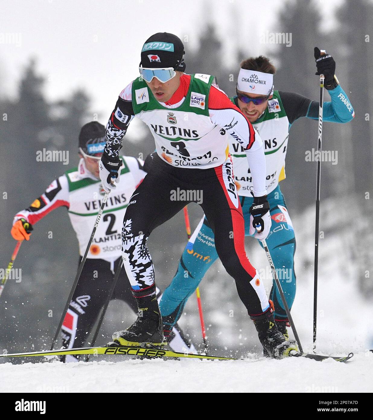 Japanese Akito Watabe (C) competes during the cross country portion of ...