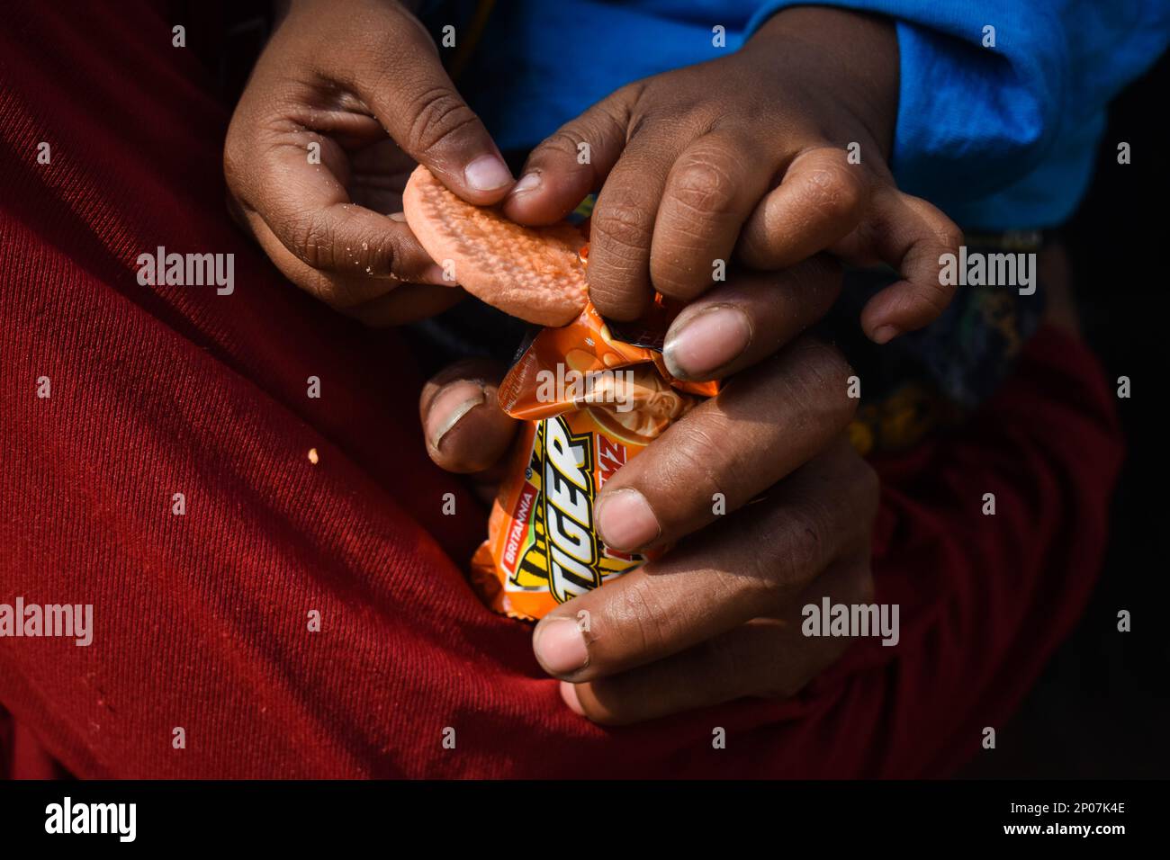Kolkata, India. 02nd Mar, 2023. A child taking biscuits from a packet ...