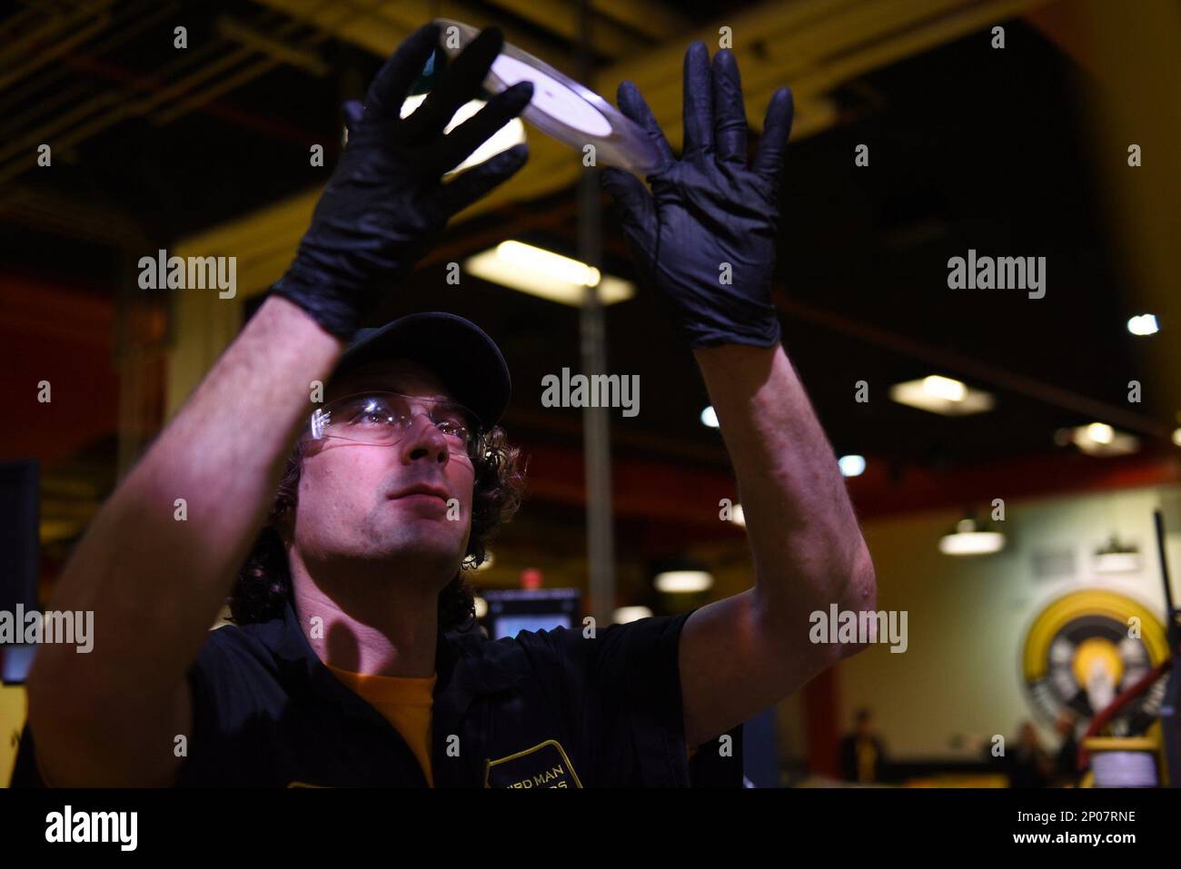Todd McNulty, of Hamtramck, takes a closer look at a freshly pressed ...