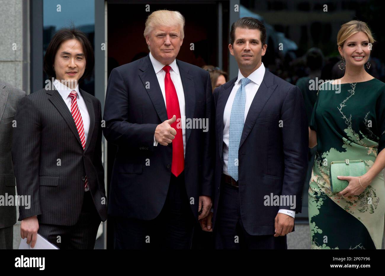 In this June 19, 2013 photo, Donald Trump, center, gives the thumbs up ...