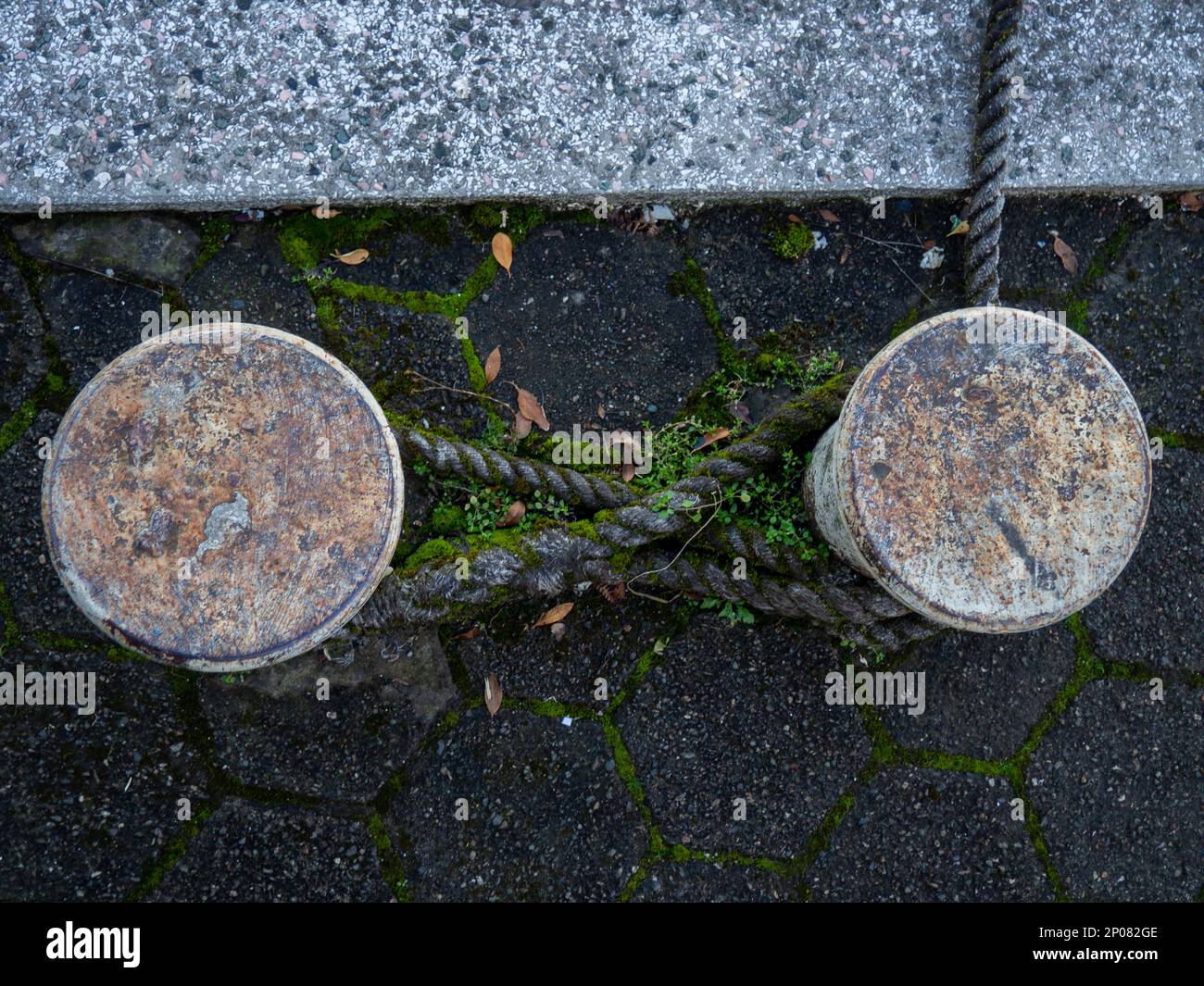 rope goes into the water from the bollard. Attaching boats to the pier ...