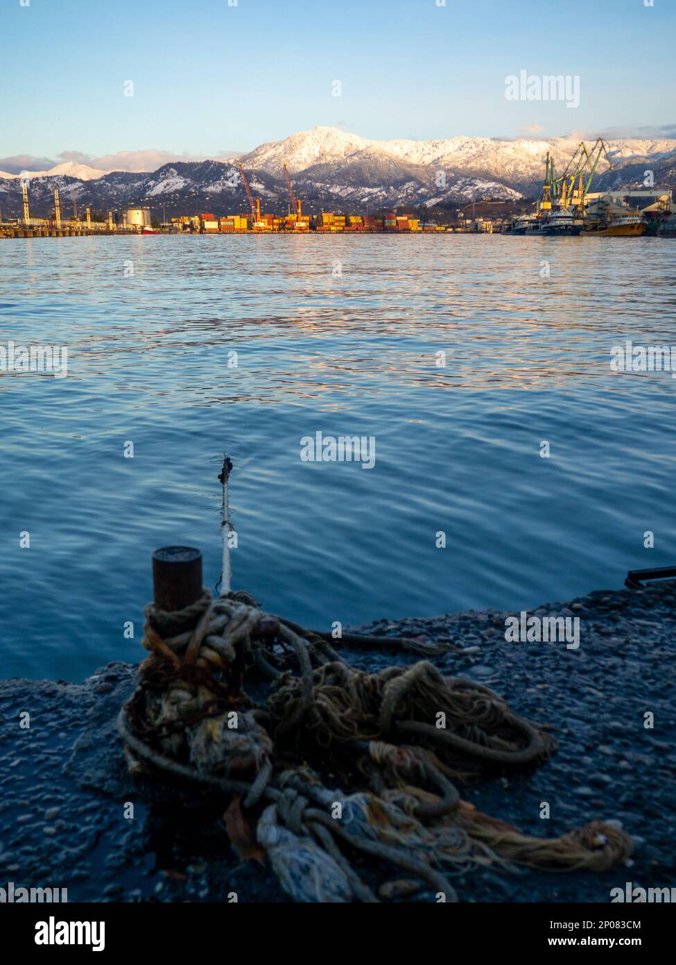 rope goes into the water from the bollard. Attaching boats to the pier ...