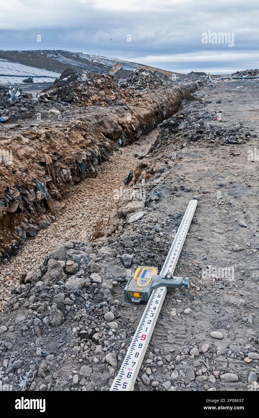 An electronic measuring device with a ruler component alongside a rock ...