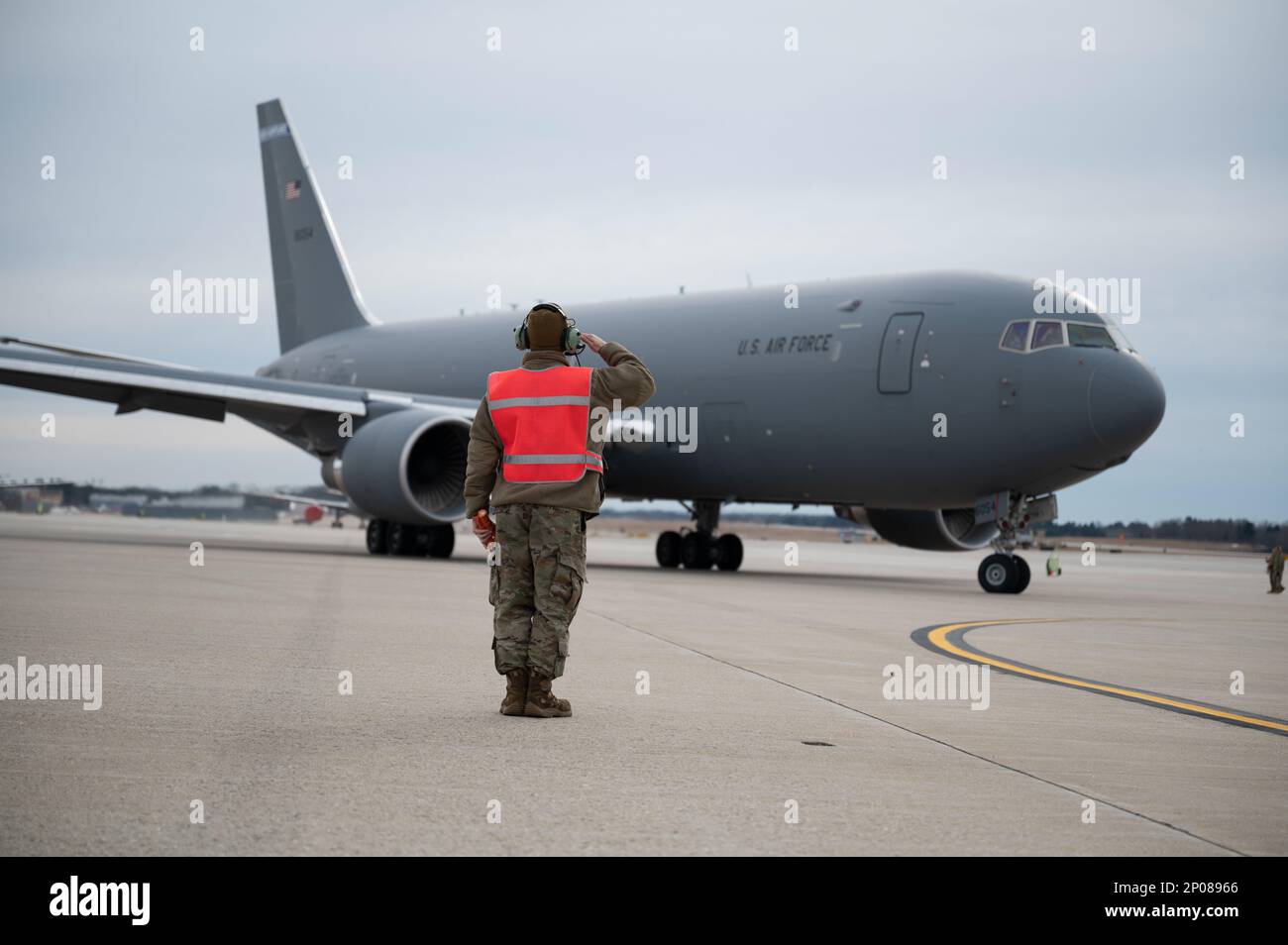 Senior Airman Reid Carter, a crew chief with the 64th Air Refueling Squadron, marshals a KC-46 ...