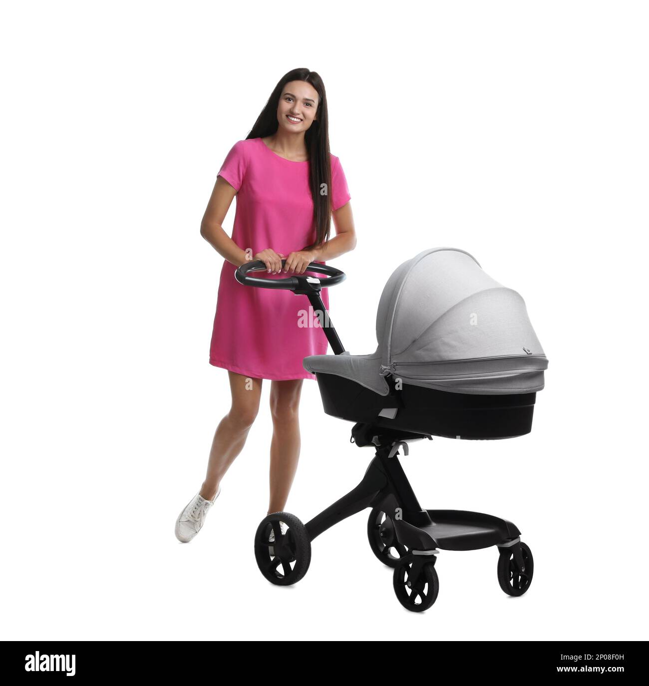 Happy young woman with baby stroller on white background Stock Photo ...