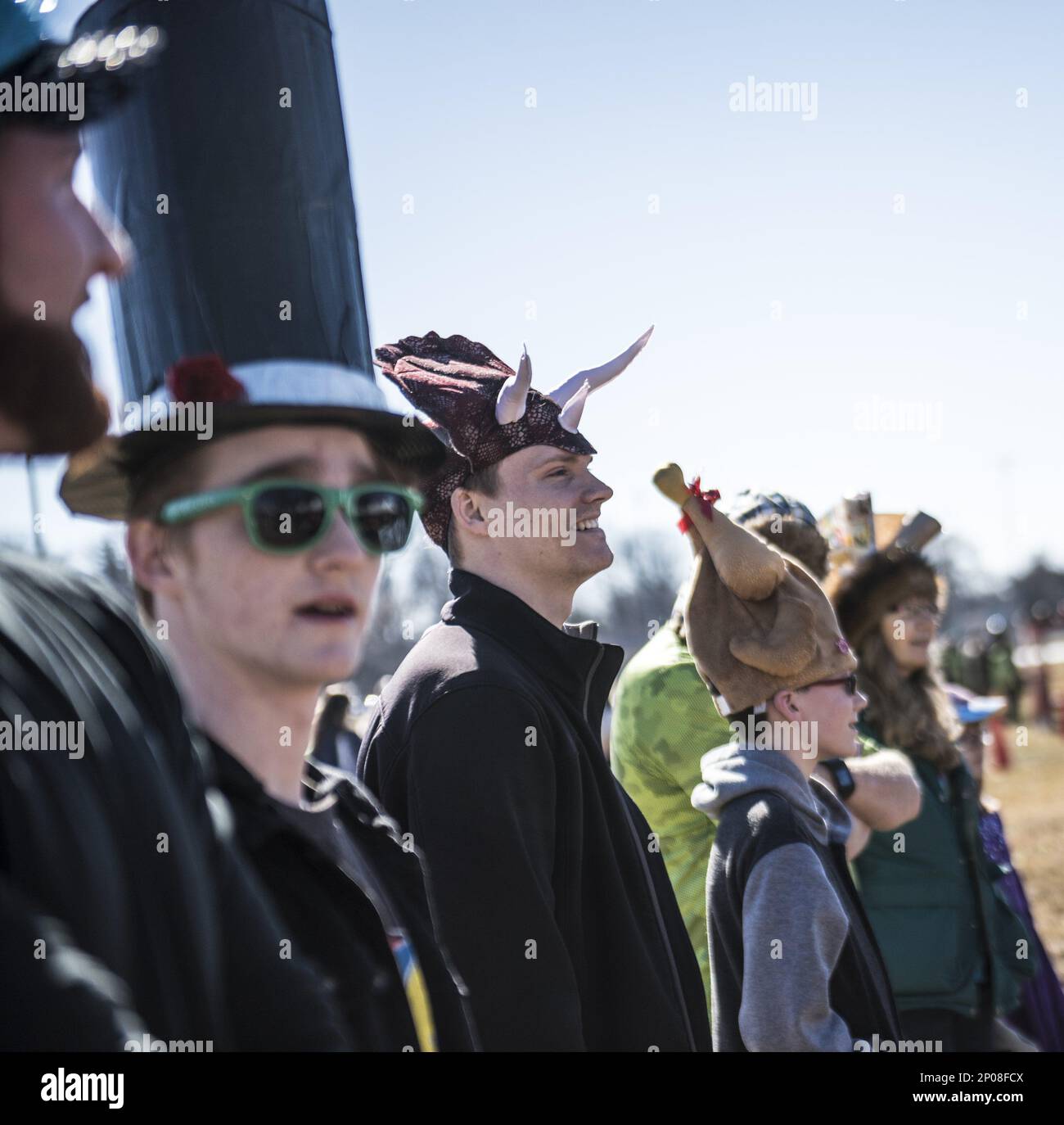 People line up for the crazy hat contest during the fourth annual ...