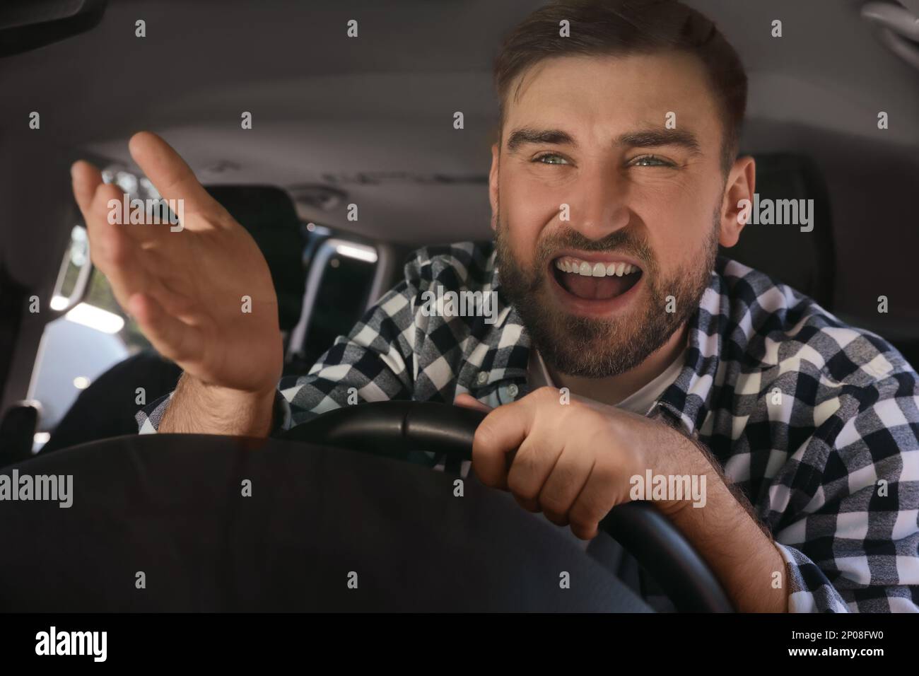 Emotional man in car. Aggressive driving behavior Stock Photo - Alamy