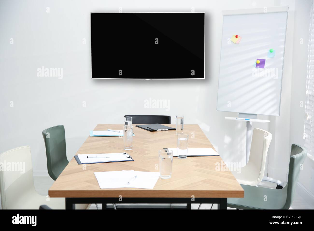 Modern wide screen TV on white wall in conference room Stock Photo - Alamy