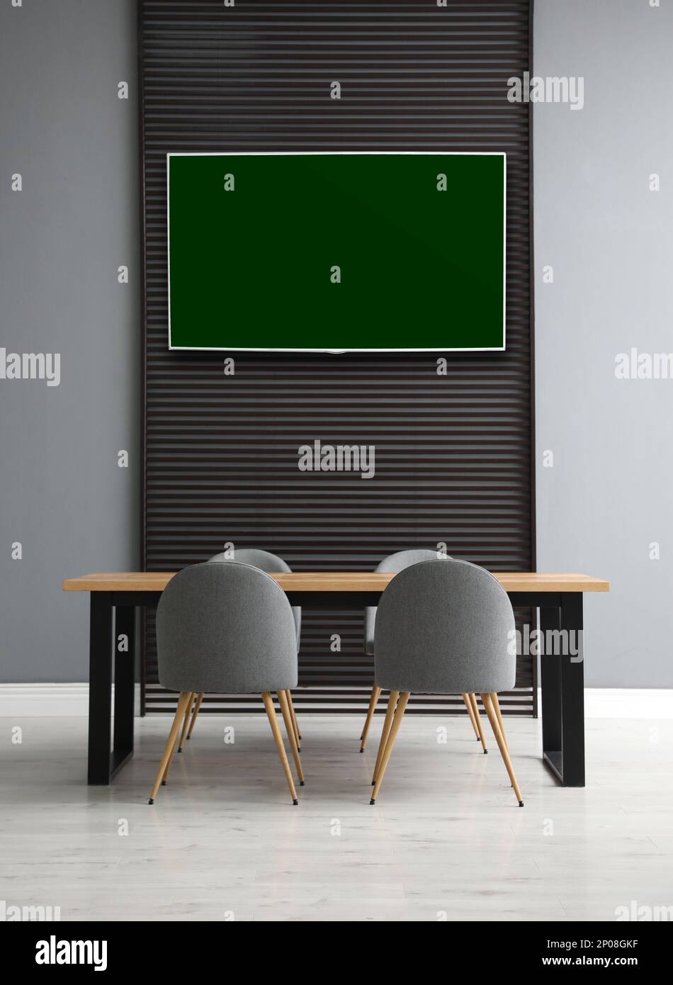 Modern wide screen TV on wall in room with stylish furniture Stock ...