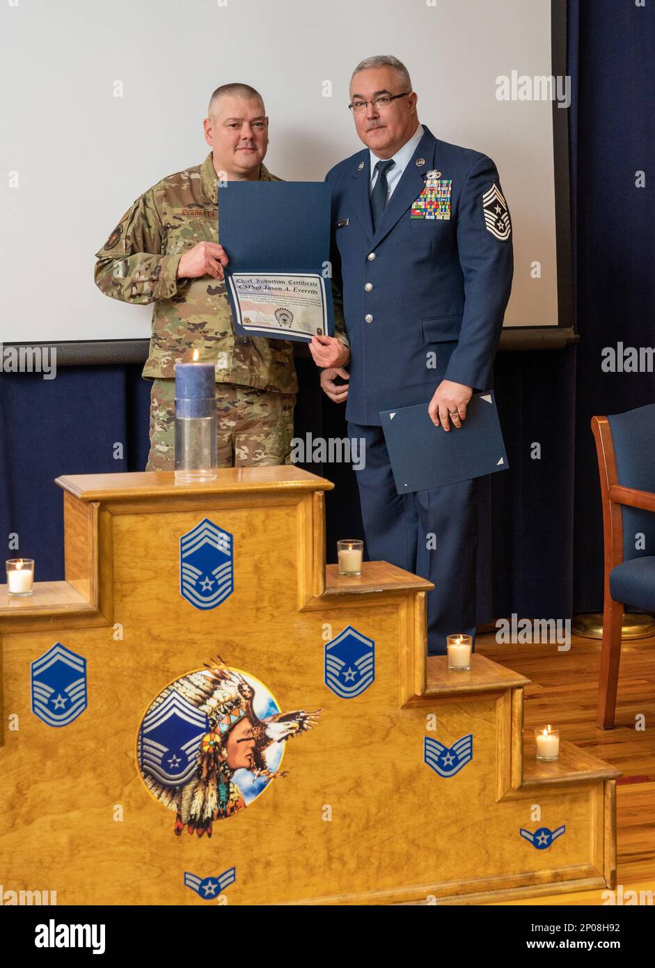 Chief Master Sgt. Jason Everetts, left, is presented a certificate from ...