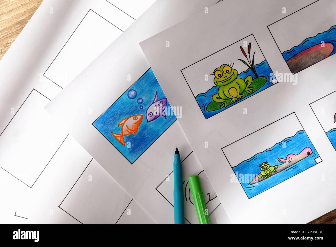 Storyboards with cartoon sketches at workplace, flat lay. Pre ...