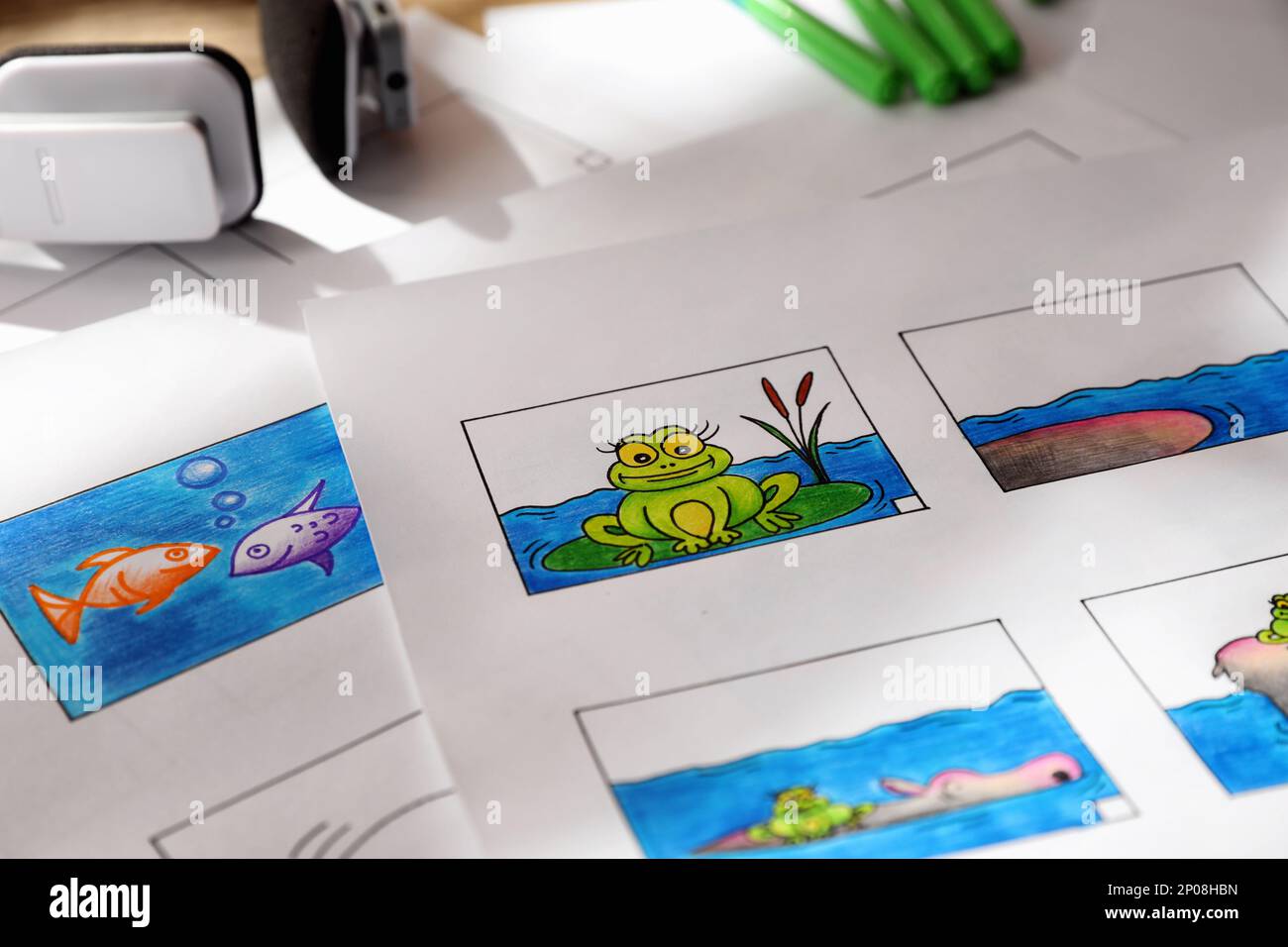 Storyboards with cartoon sketches at workplace. Pre-production process ...