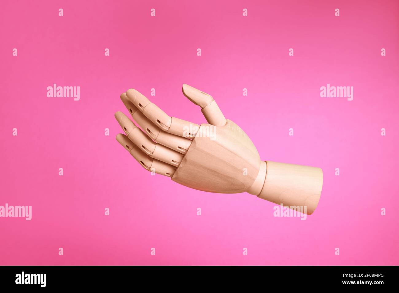 Wooden hand model on pink background. Mannequin part Stock Photo - Alamy