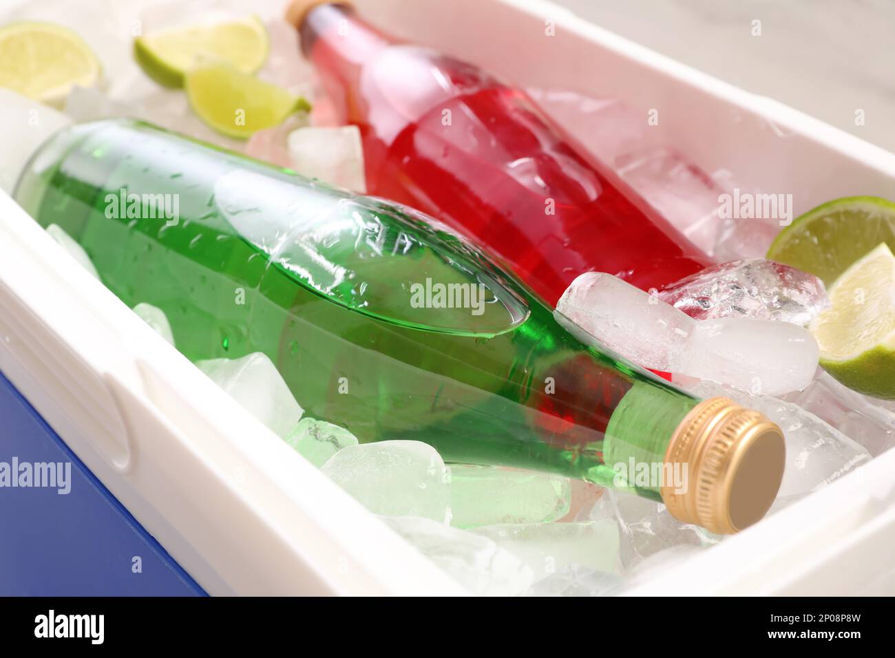 Plastic cool box with ice cubes and refreshing drinks, closeup Stock ...