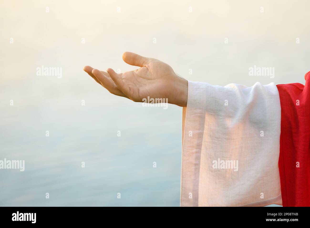 Jesus Christ reaching out his hand near water outdoors, closeup Stock ...