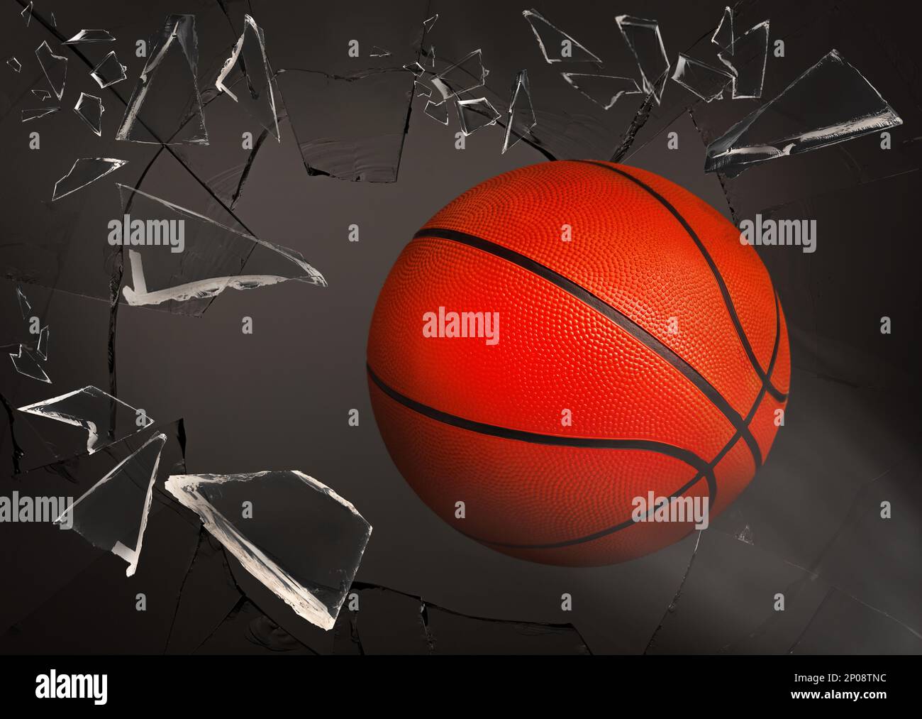 Basketball ball breaking up glass against grey background Stock Photo ...