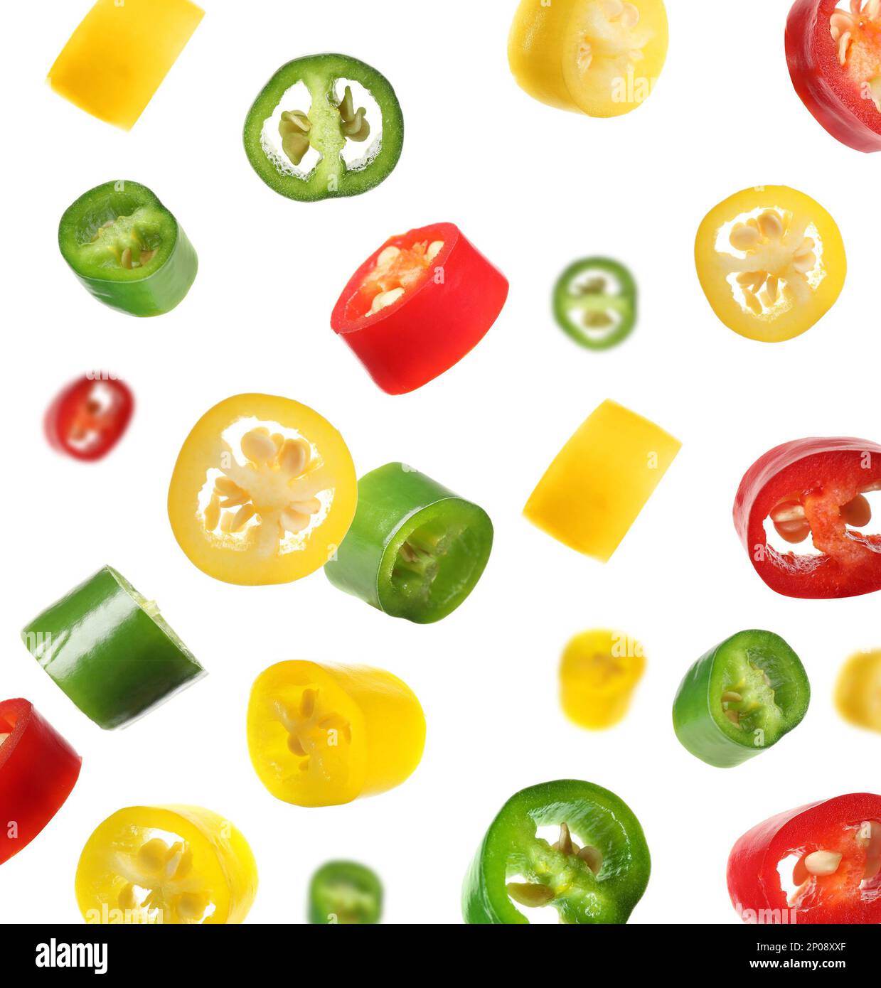 Pieces of different chili peppers falling on white background Stock ...