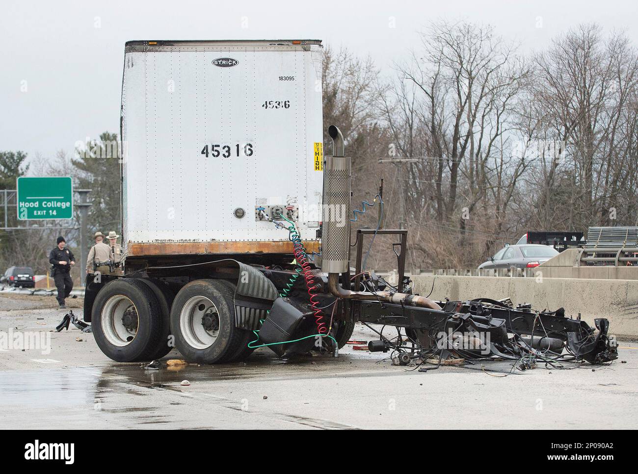 Investigators look over the scene of a tractor-trailer after a crash on ...