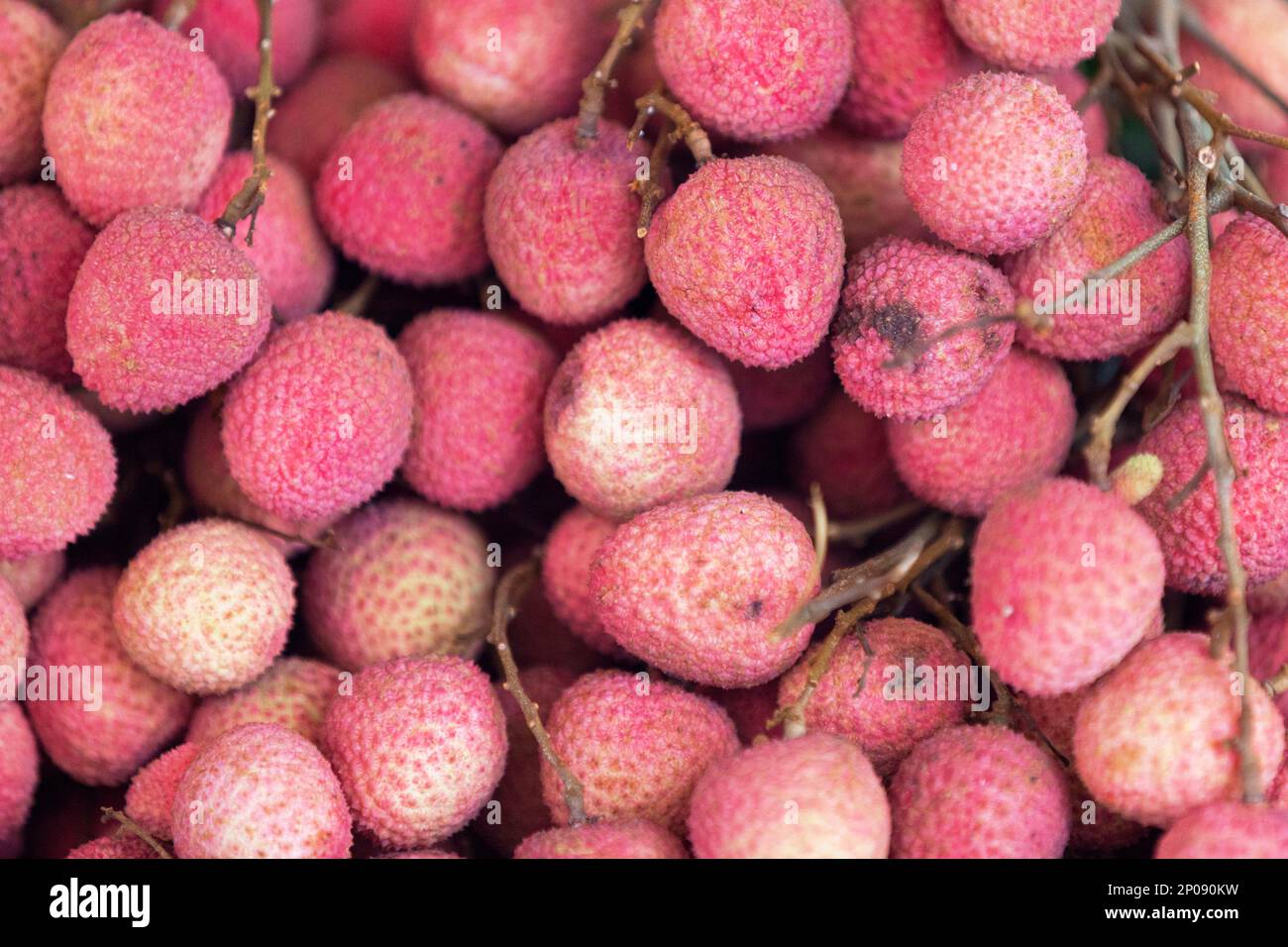 Close-up on a stack of Lychees on a market stall Stock Photo - Alamy