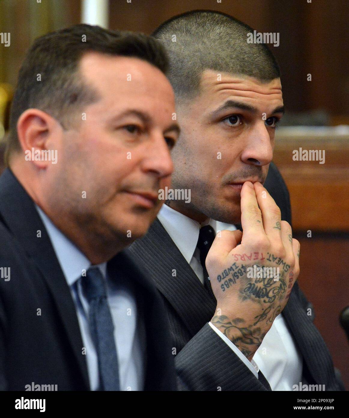 Lead defense attorney Jose Baez, left, and Aaron Hernandez listen to ...
