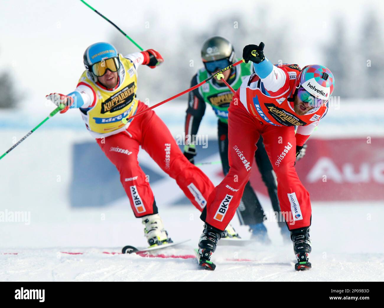 Swiss skier Alex Fiva, right, crosses the finish line to win the men's ...