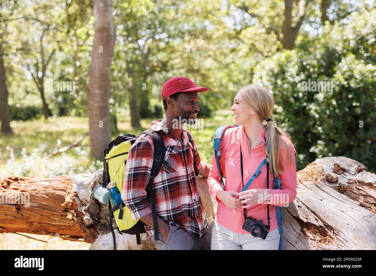 Happy diverse couple backpacks hi-res stock photography and images - Alamy