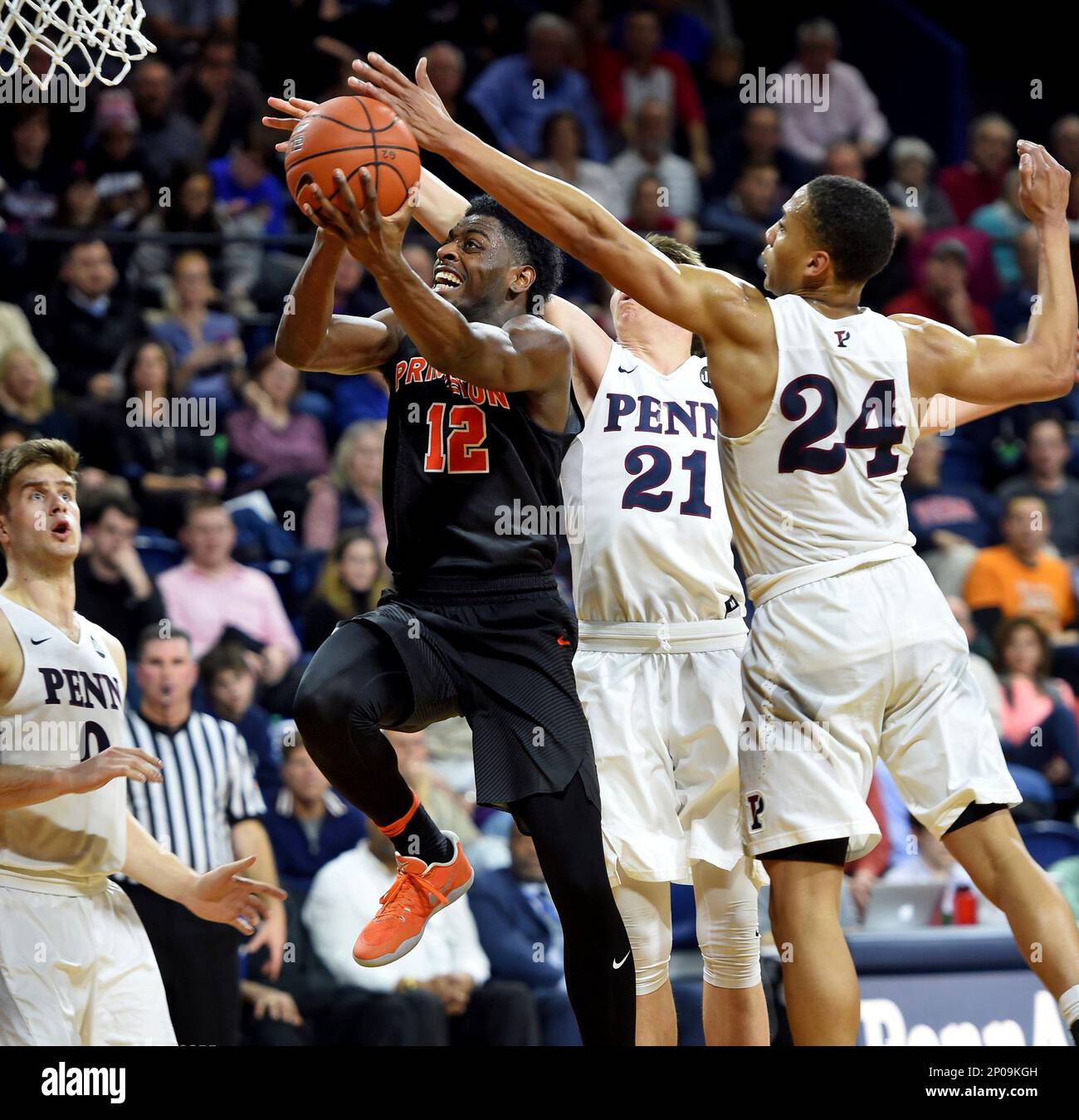Princeton's Myles Stephens (12) drives past Penn's Ryan Betley (21 ...