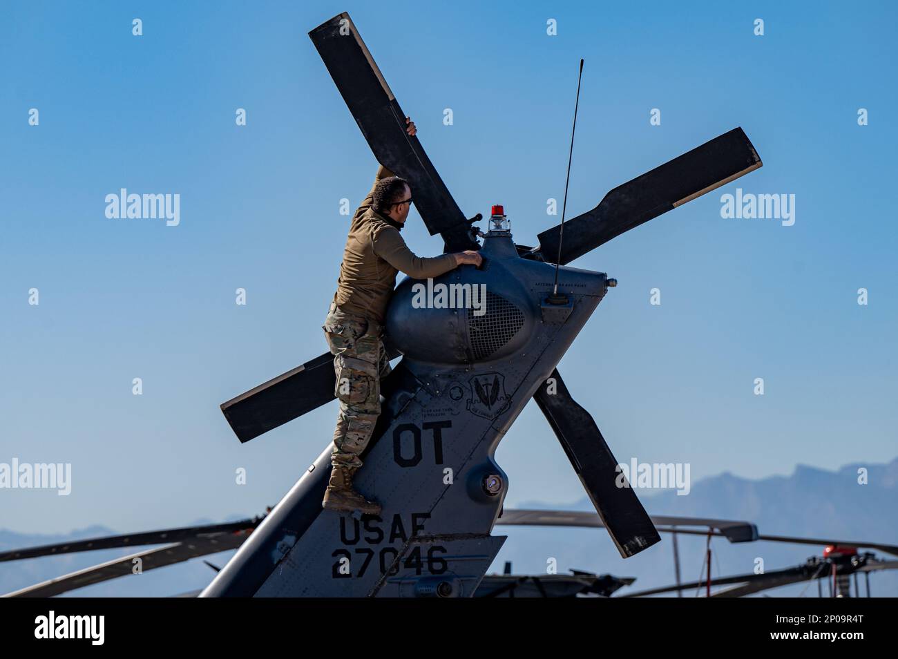 A U.S. Air Force Airmen performs preflight checks on an HH-60G Pave ...