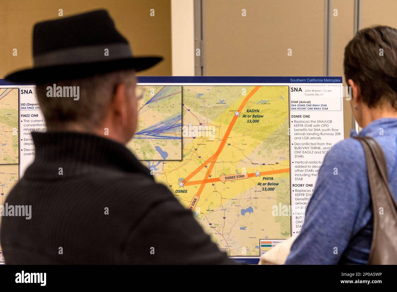 People read charts showing new flight paths for the Southern California ...