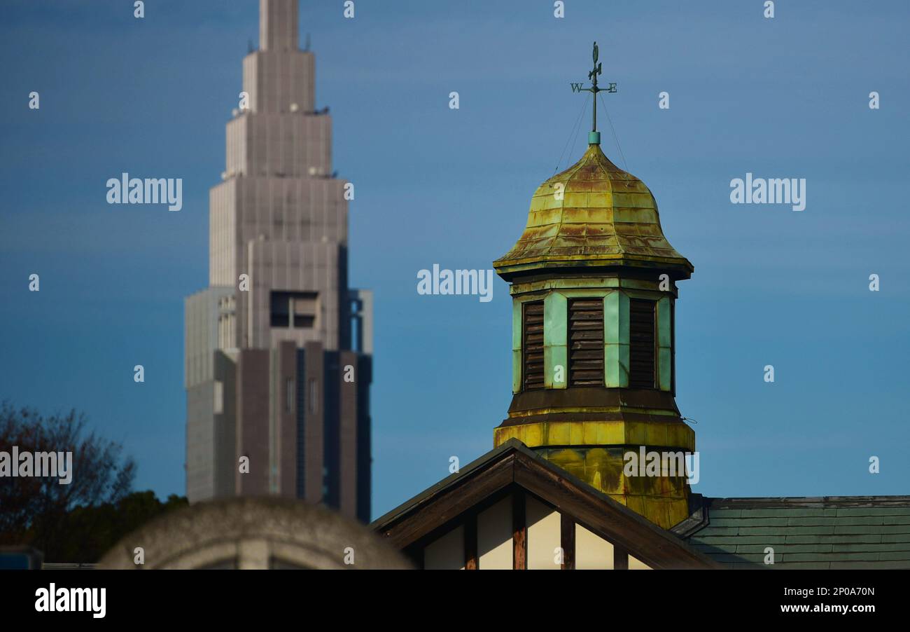 A retro building of Harajuku Station with a skyscraper in the ...