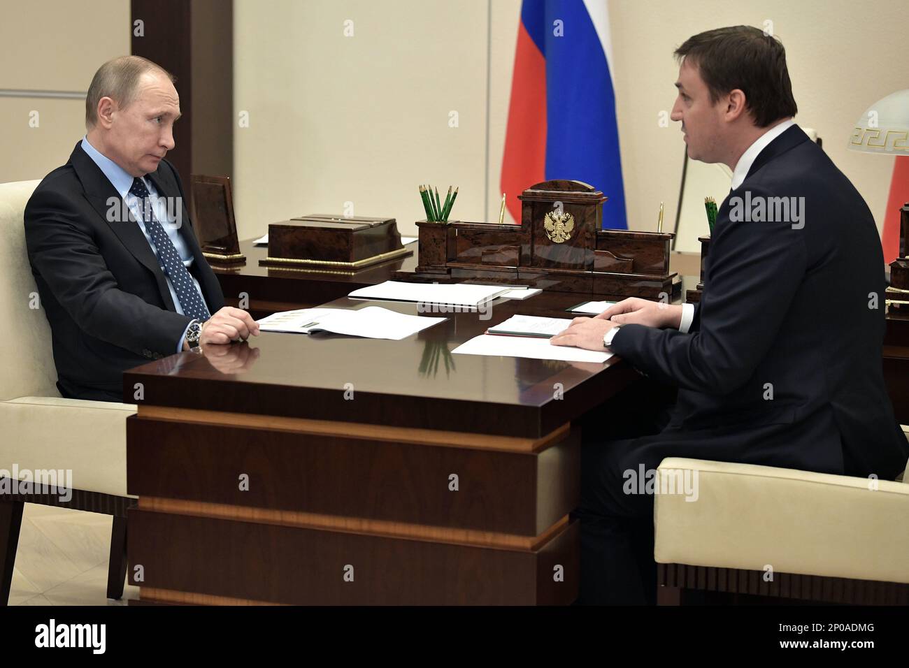 Russian President Vladimir Putin, left, listens to Chairman of the ...