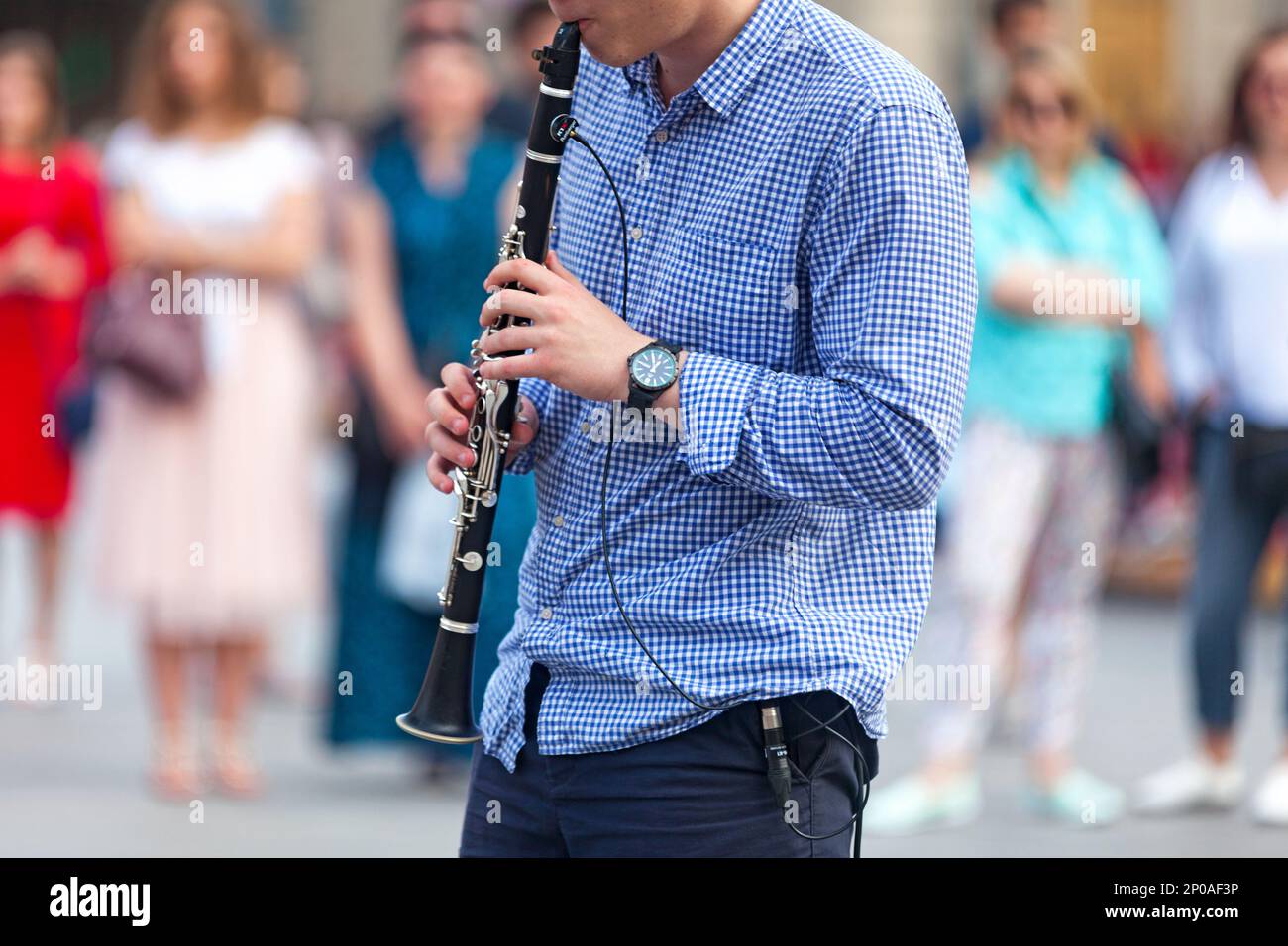 Musician playing with his electric clarinet during an outdoors free ...