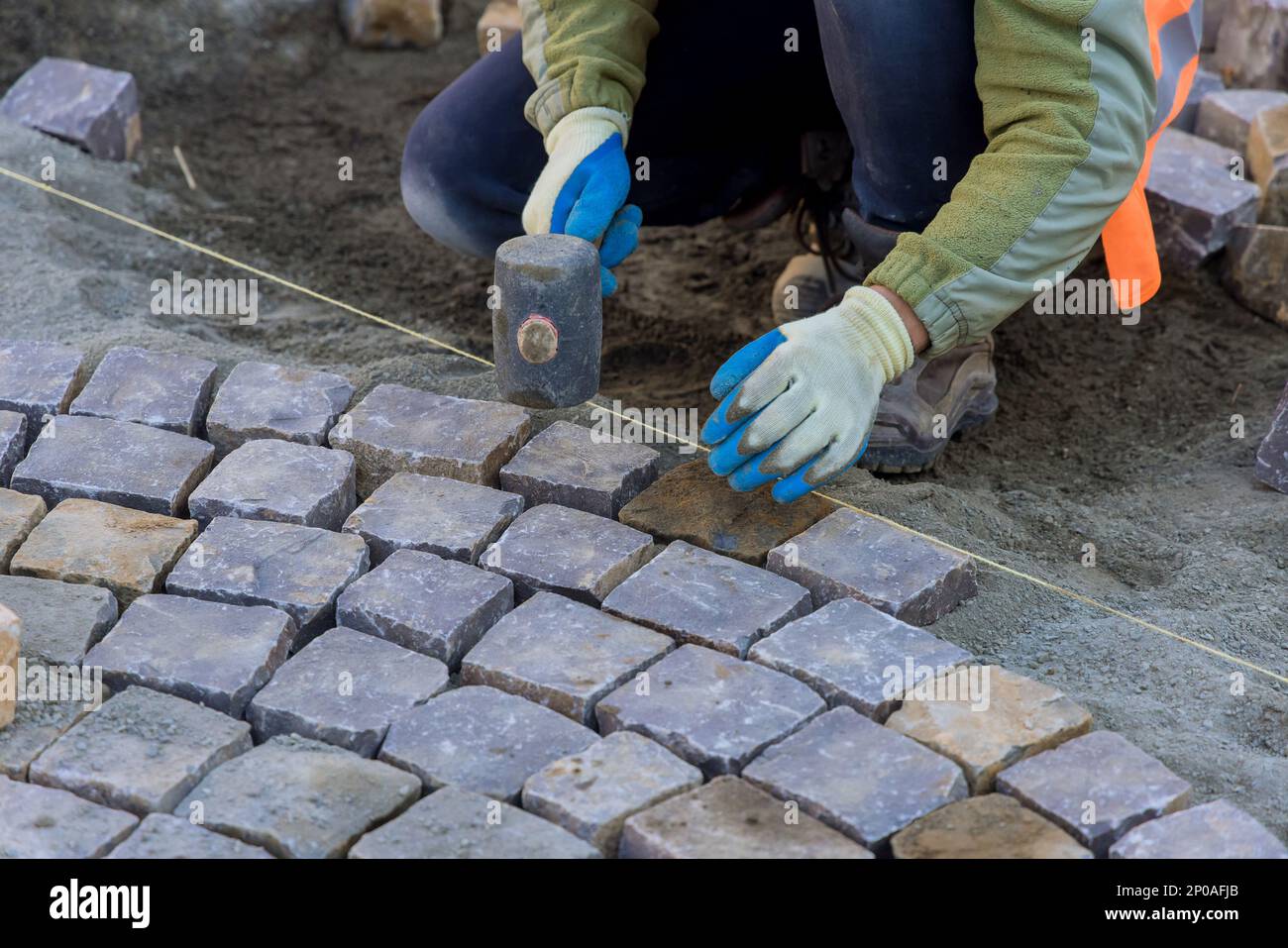 Sound of workers hammering granite stones into place echoed through ...