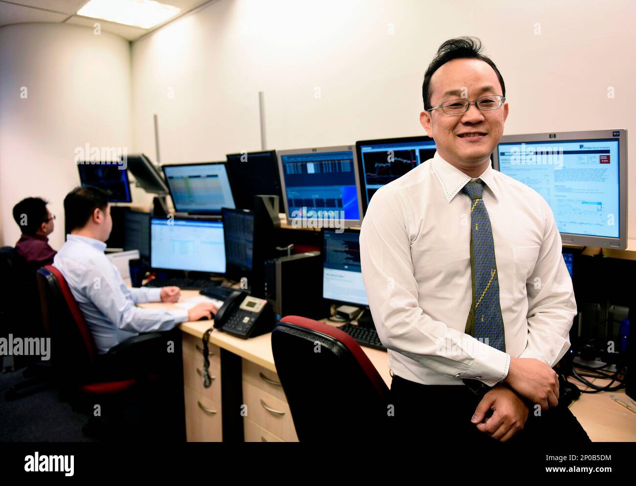 Phillip Securities executive director Mr Luke Lim with the Poems Mercury (behind), a new trading ...