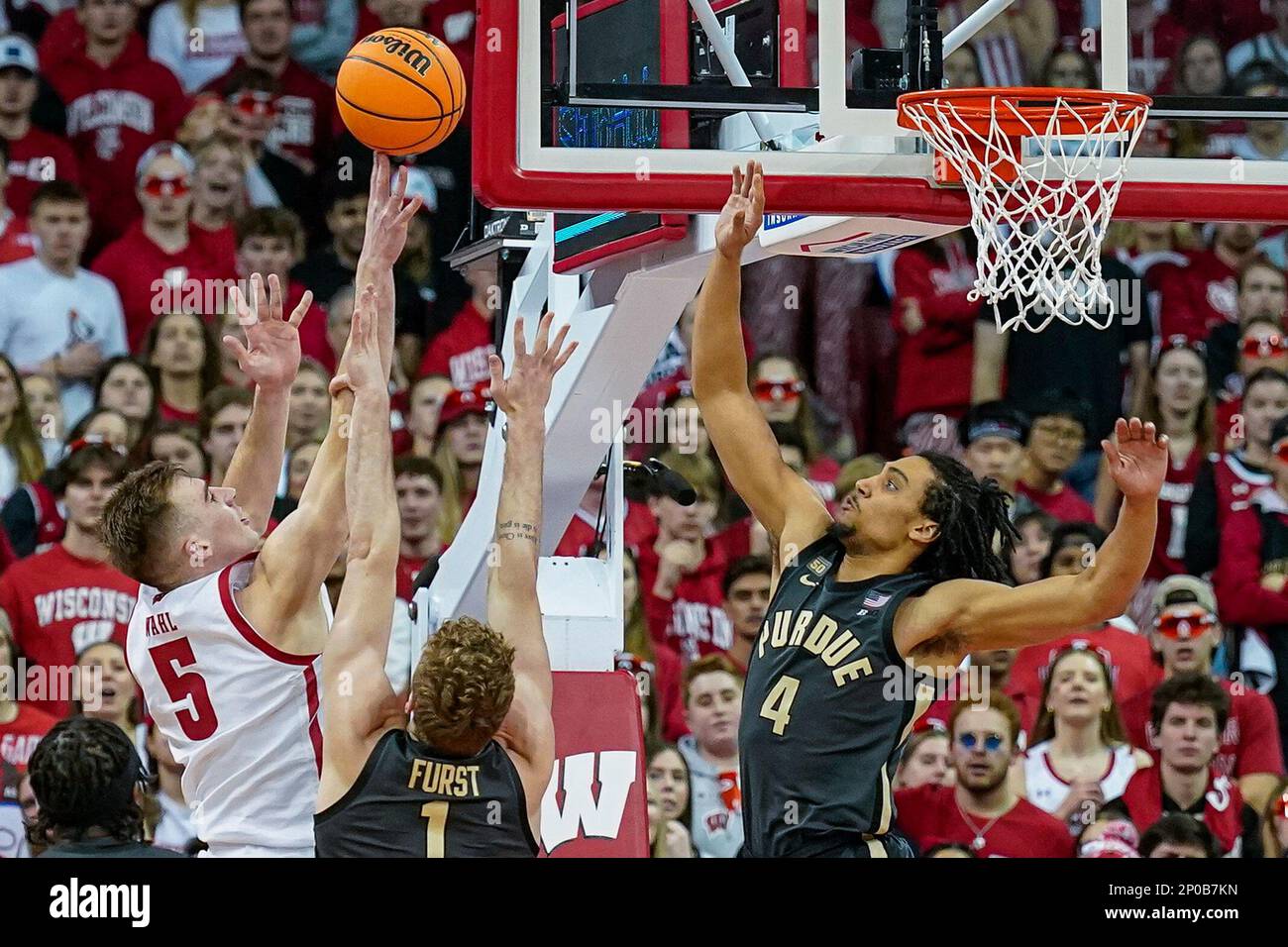 Wisconsin's Tyler Wahl (5) shoots against Purdue's Caleb Furst (1) and ...