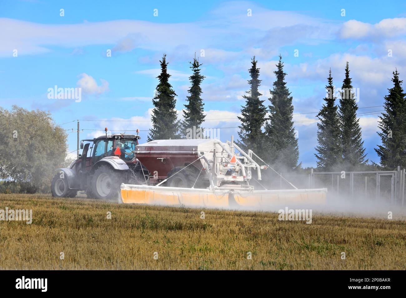 Tractor and spreader spreading agricultural lime, a soil additive made ...
