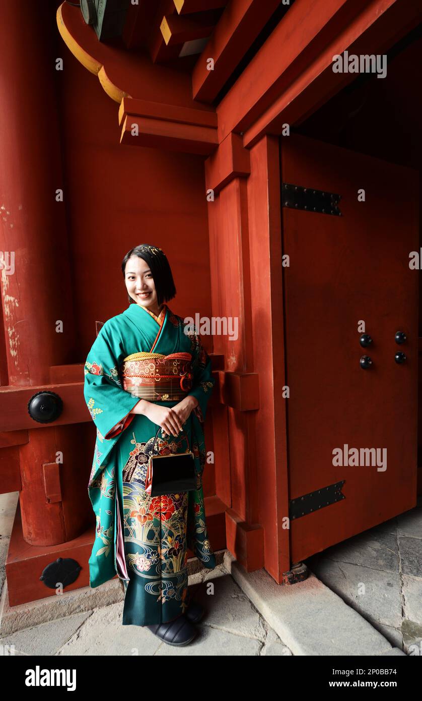 A young Japanese woman wearing a traditional Kimono at the Tsurugaoka ...