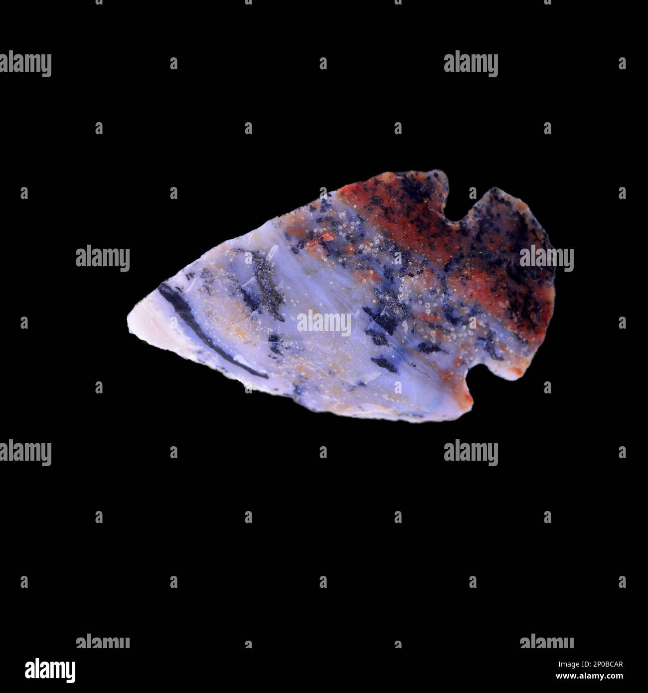 Ancient Prehistoric primitive stone arrowhead isolated over black Stock ...