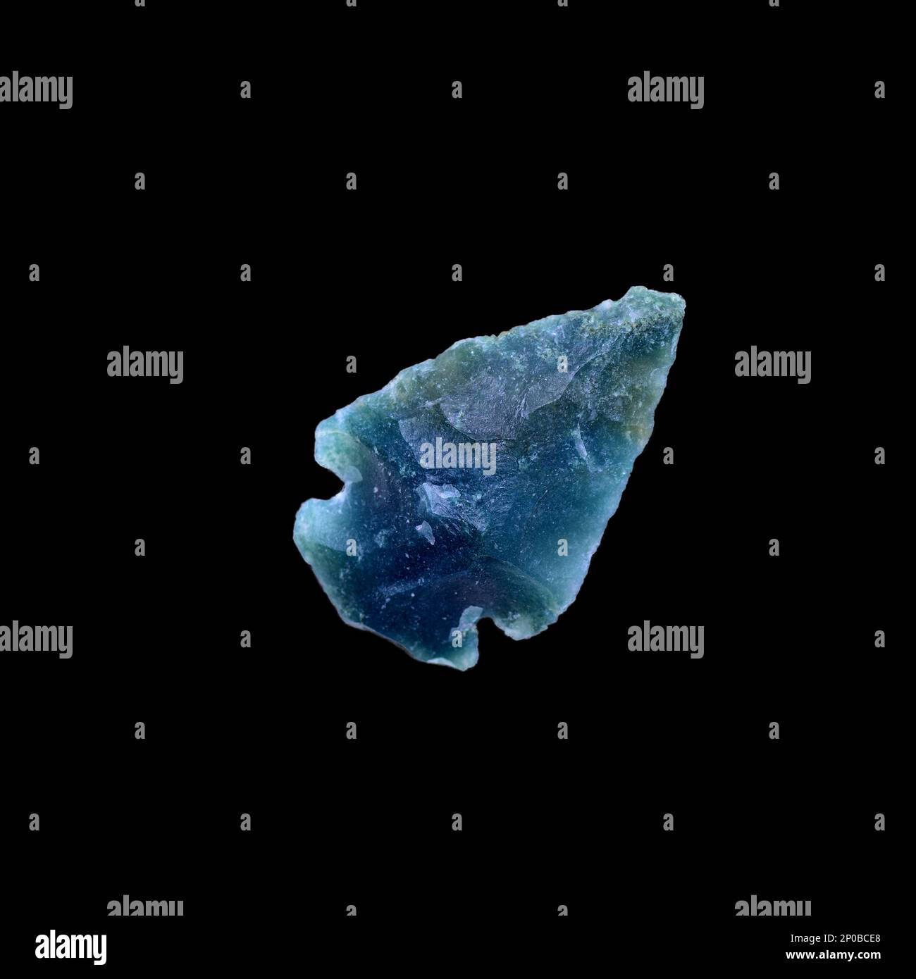 Ancient Prehistoric primitive stone arrowhead isolated over black Stock ...