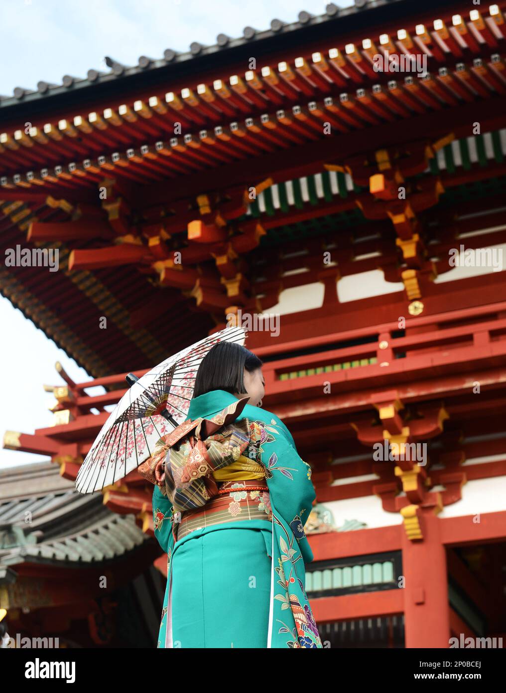 A young Japanese woman wearing a traditional Kimono and holding an Oil ...